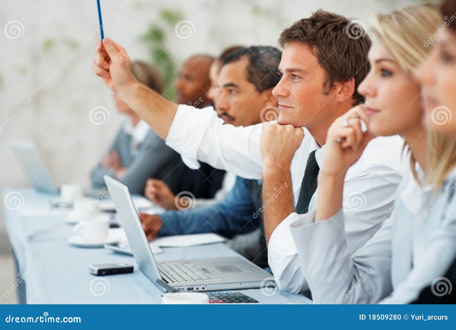 Stock Photo: Business man asking a question during meeting. Image: 18509280