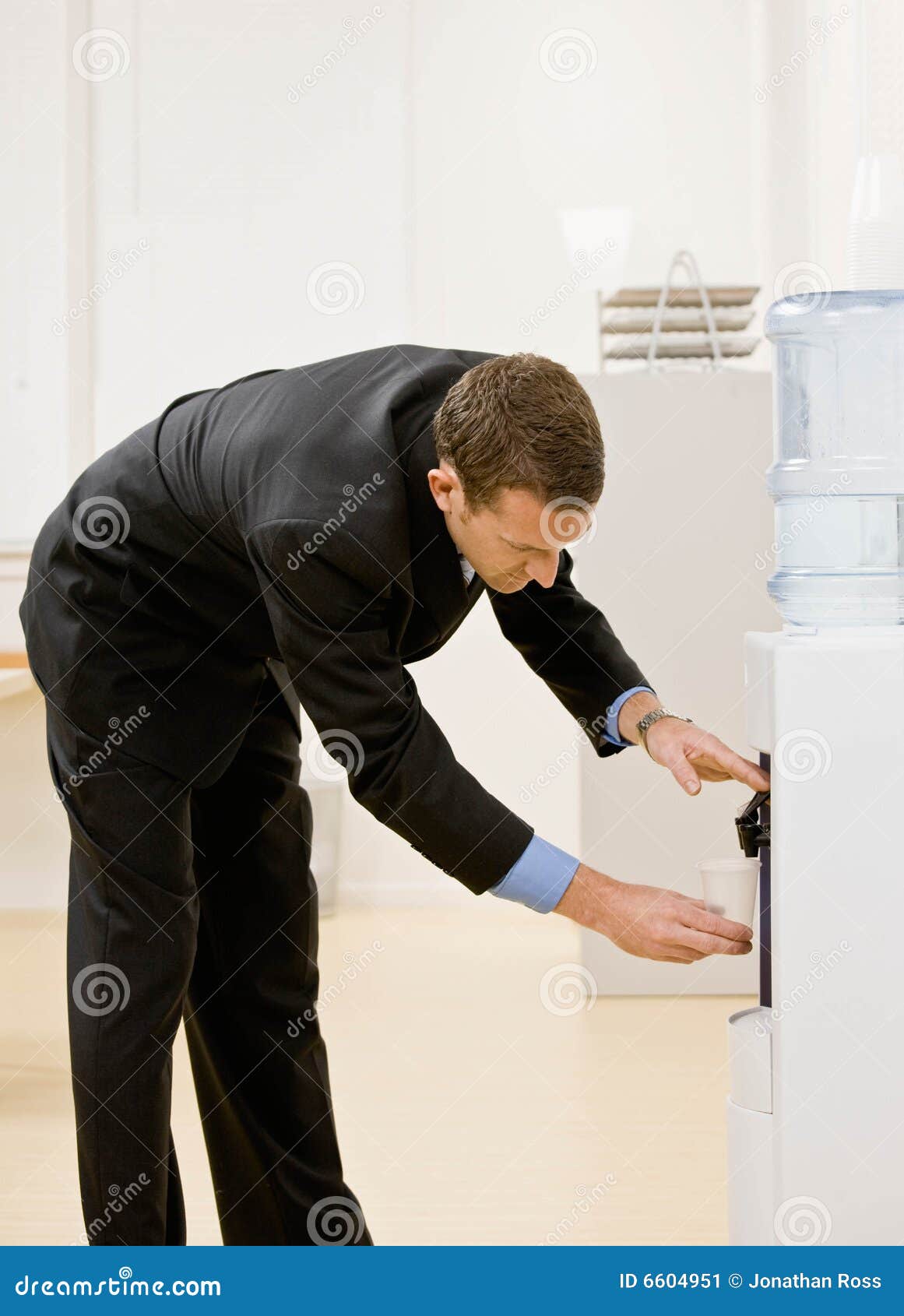 Business Man Gets Water from Water Cooler Stock Image - Image of ...