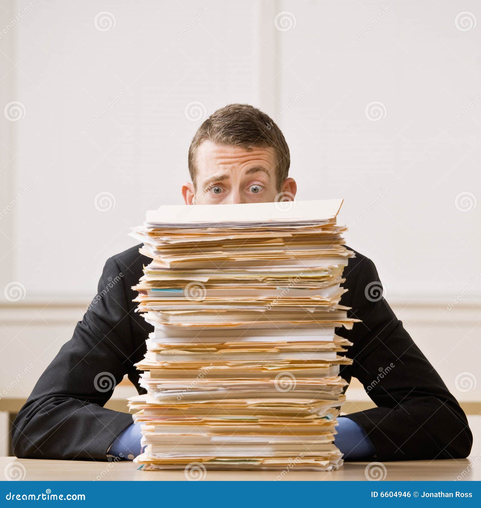 Business Man Hiding Behind Tall Stack of Folders Stock Photo - Image of ...