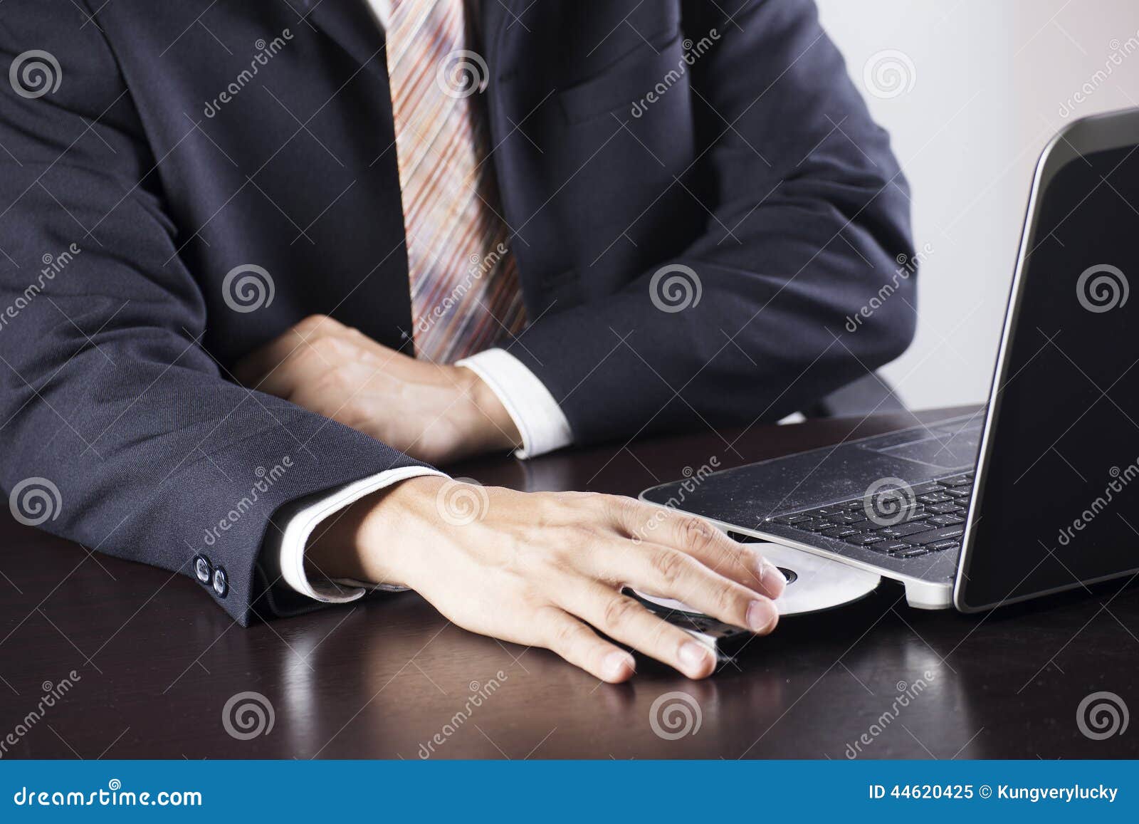 Business Man Holding Disk Insert To Laptop Stock Image - Image of ...