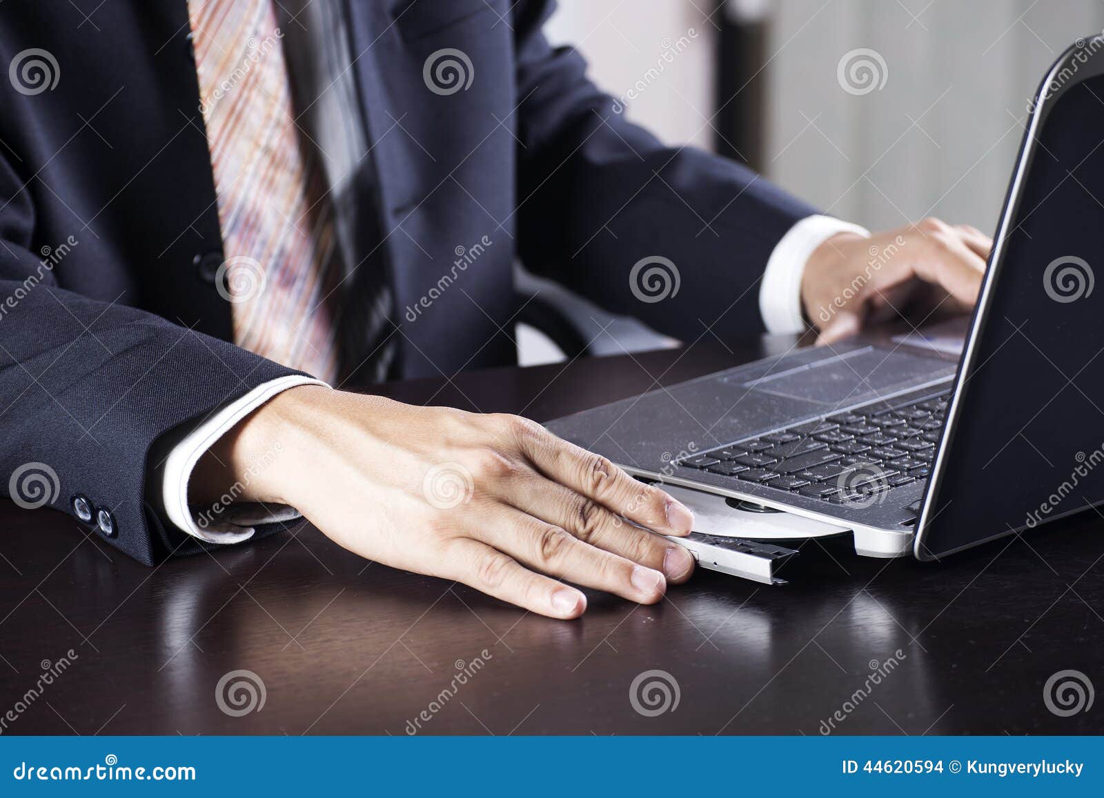 Business Man Holding Disk Insert To Laptop Stock Photo - Image of eject ...