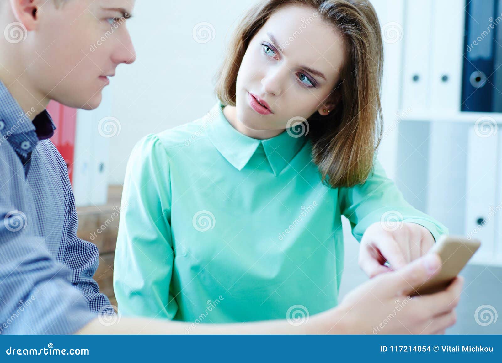 Business Man and Business Lady Watching Something on Smartphone Screen ...