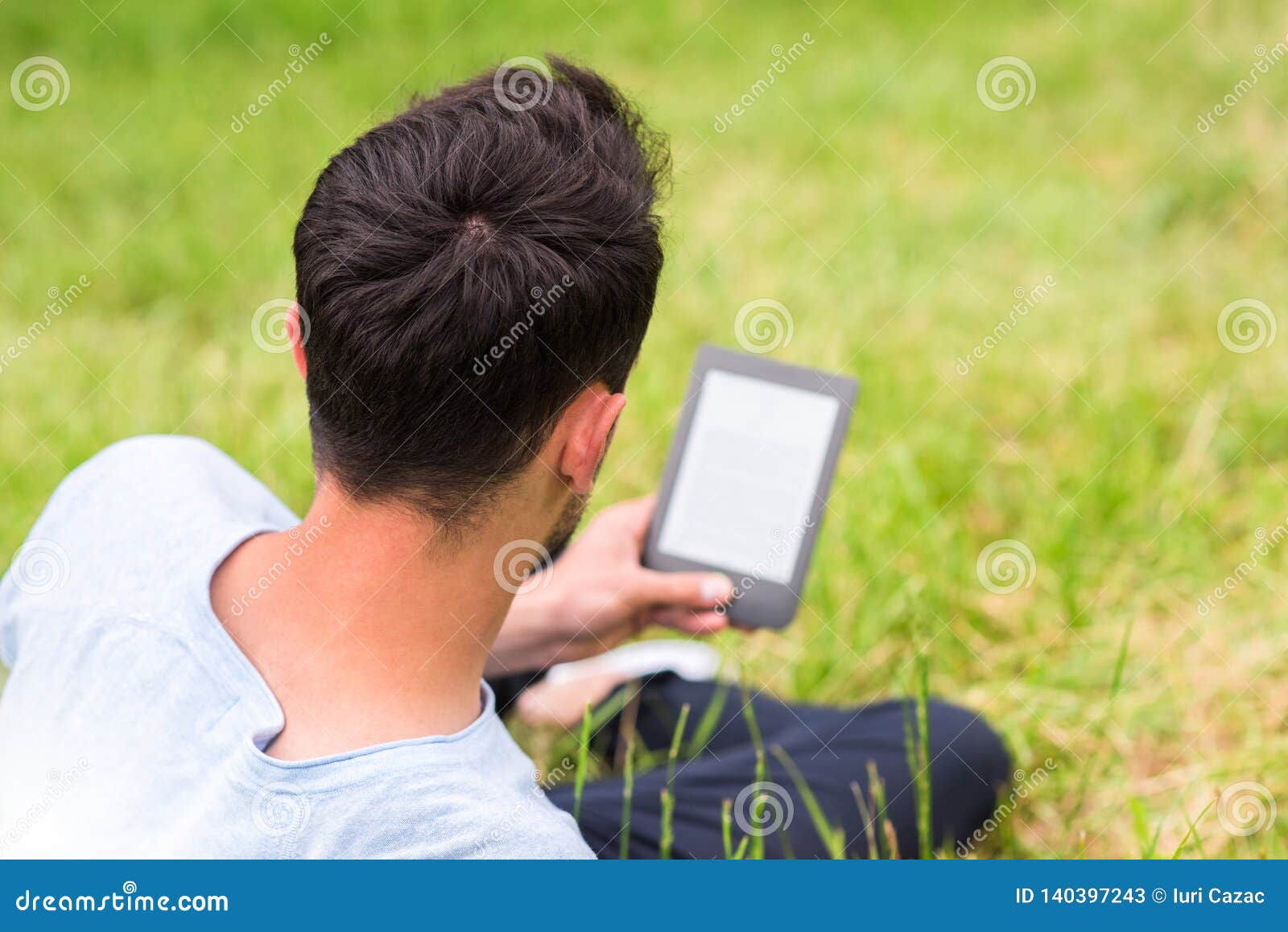 Business Man Looking from Back on Device Sitting on Green Grass Stock ...