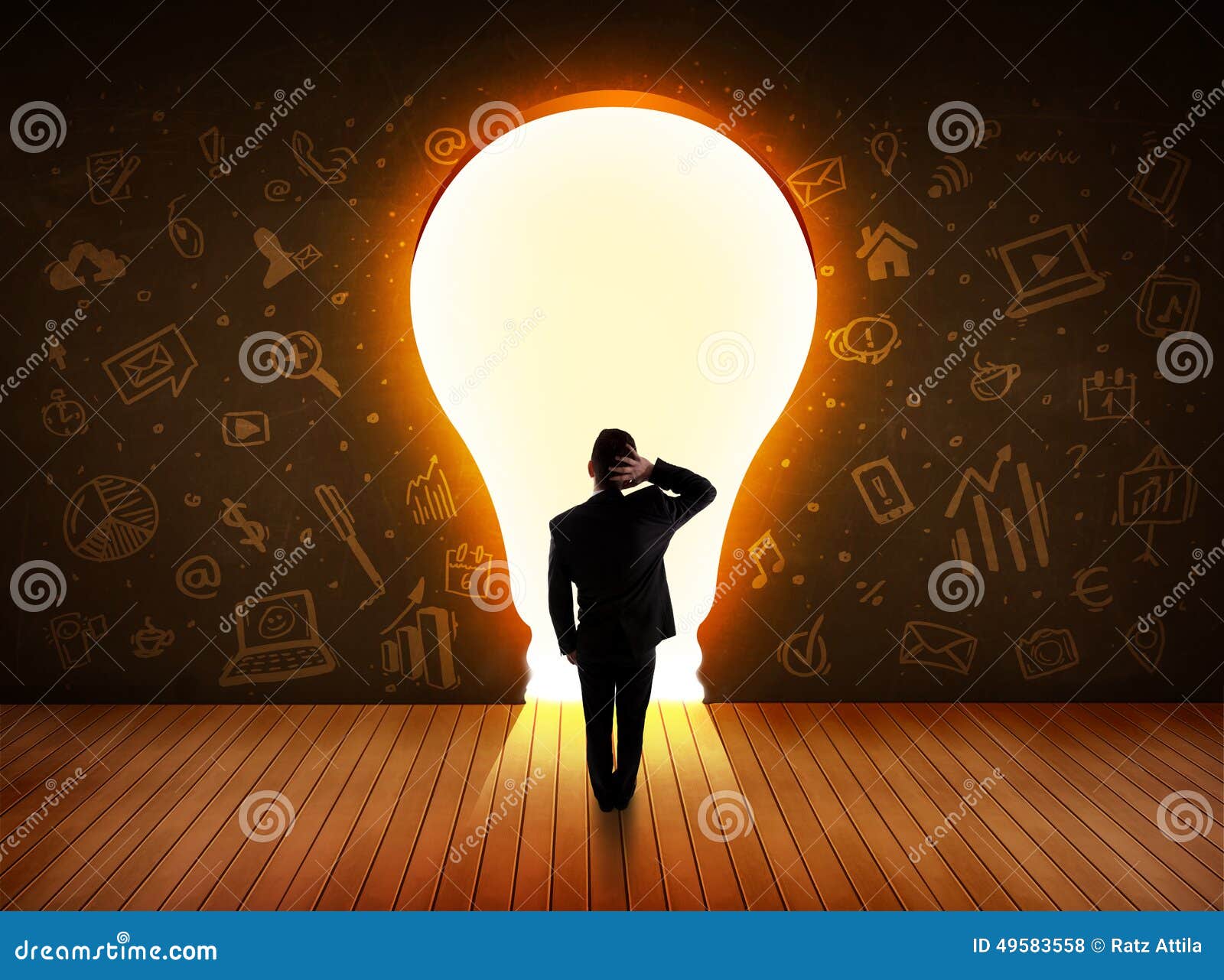Business Man Looking at Bright Light Bulb in the Wall Stock Photo ...