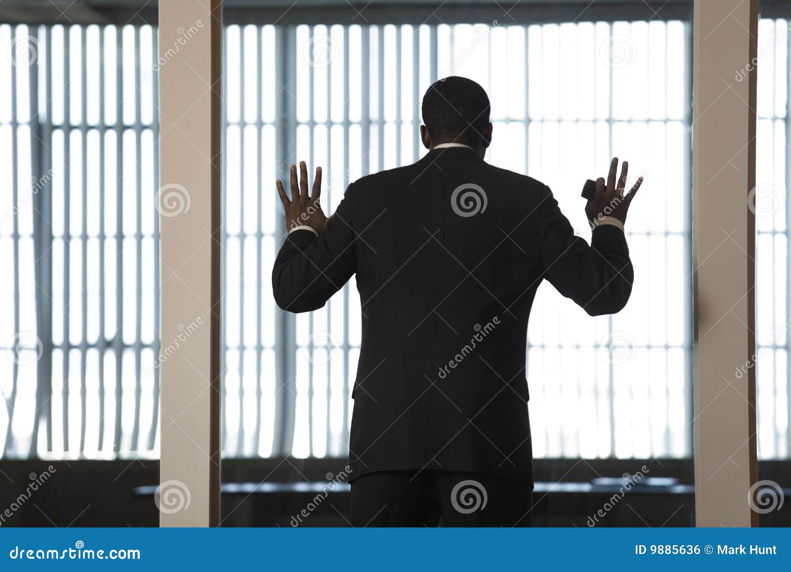 A Business Man Looking Out through a Glass Wall in Stock Photo - Image ...