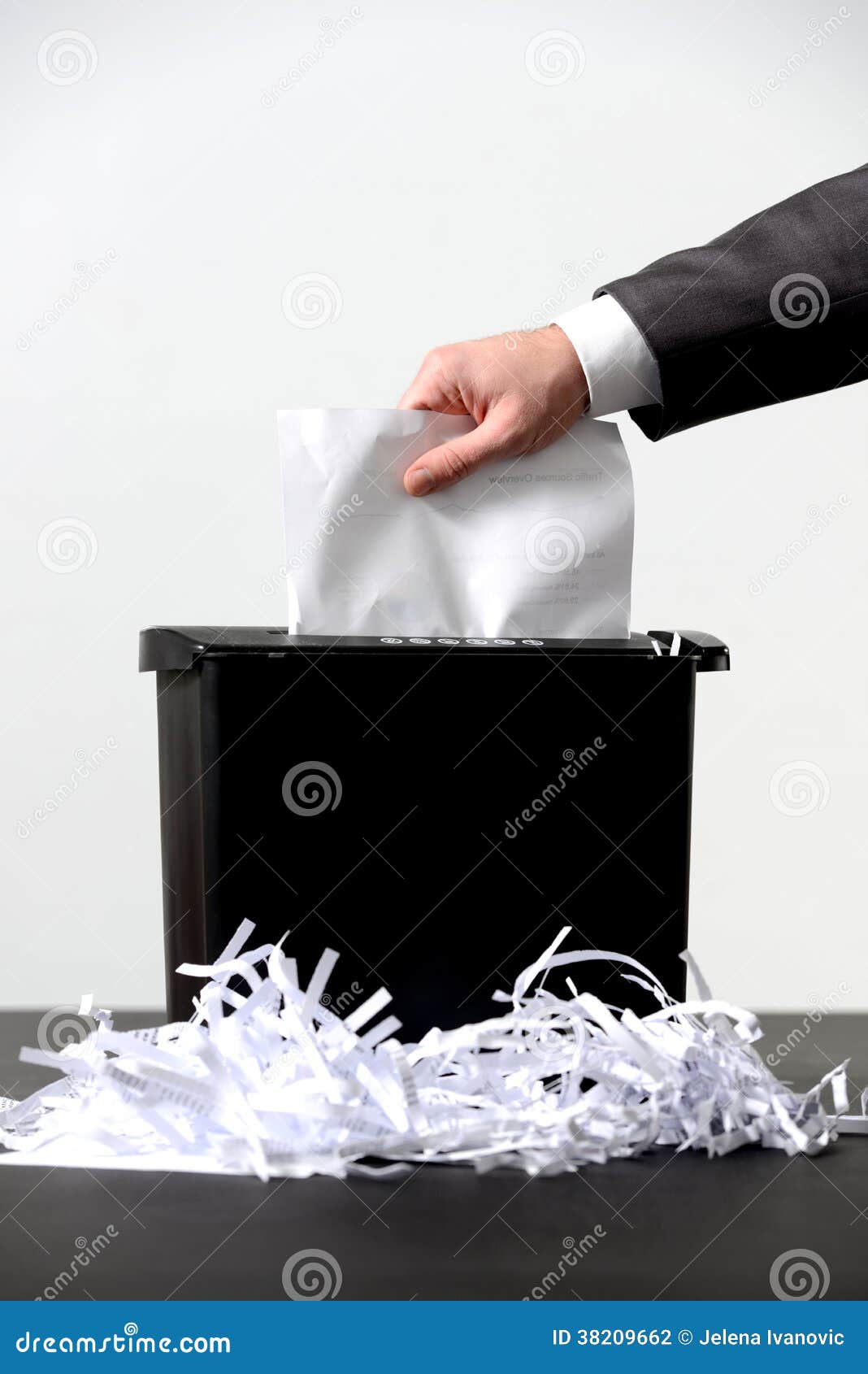 Person Shredding Paper