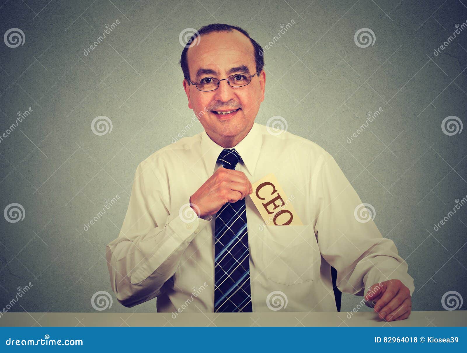 Business Man Sitting at Table Pulling Out CEO Card Stock Photo - Image ...