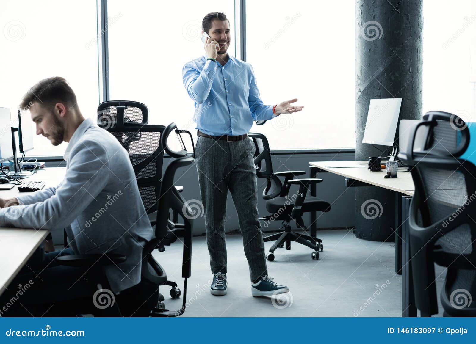 Business Man Standing Inside Office Building and Using Cell Phone ...