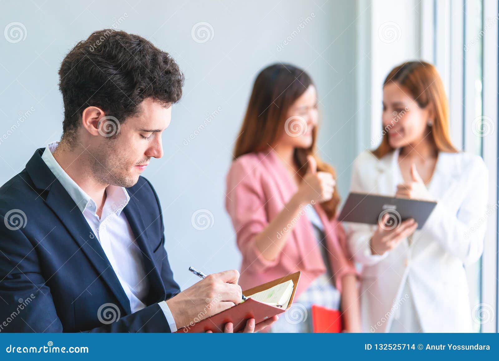 Business Man Taking Note in Front of Two Female Office Worker Stock ...