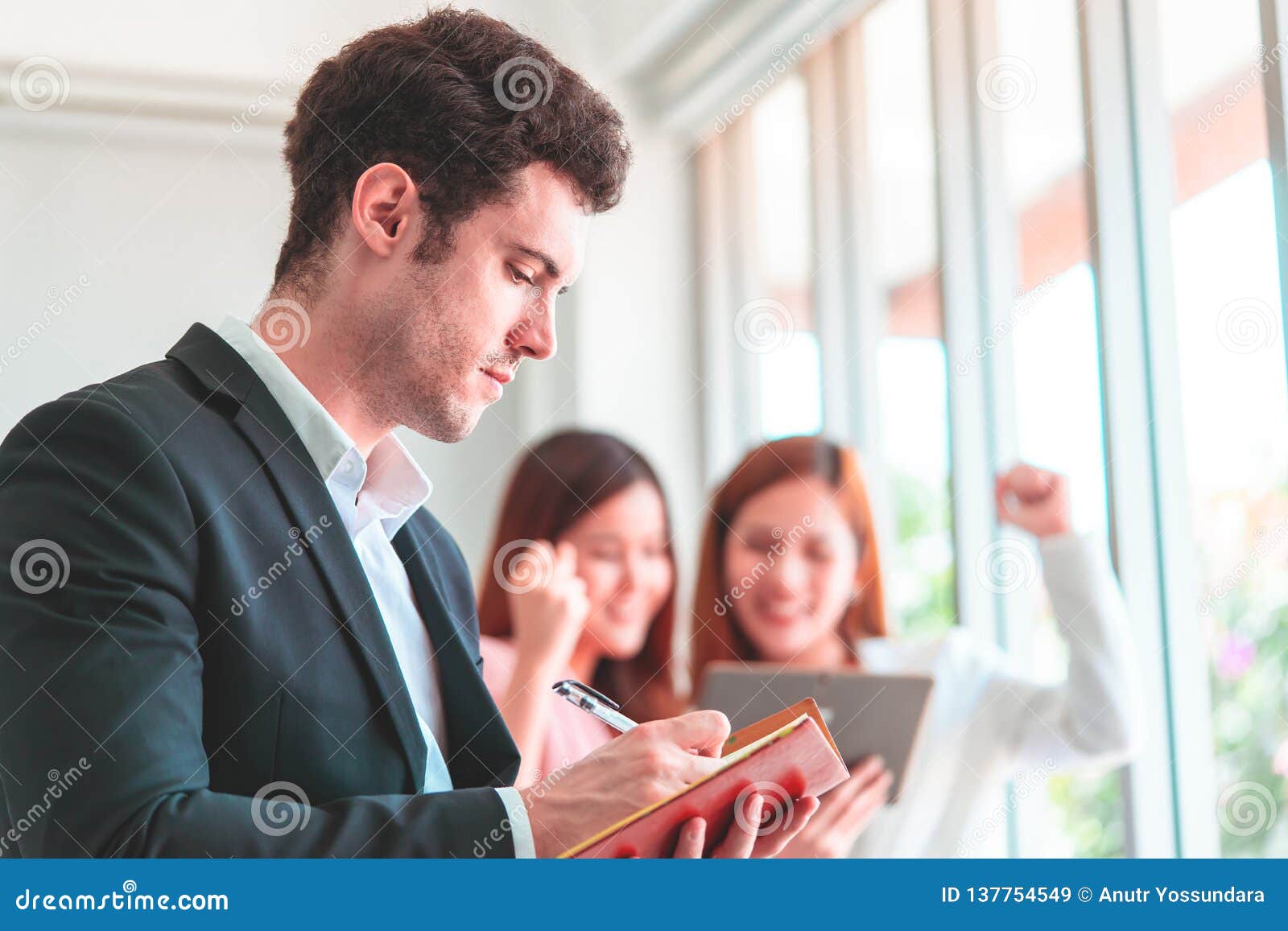 Business Man Taking Note in Front of Two Female Office Worker Stock ...