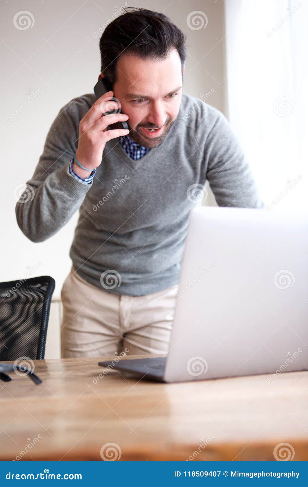 Business Man Talking on Phone and Looking at Computer Stock Image ...