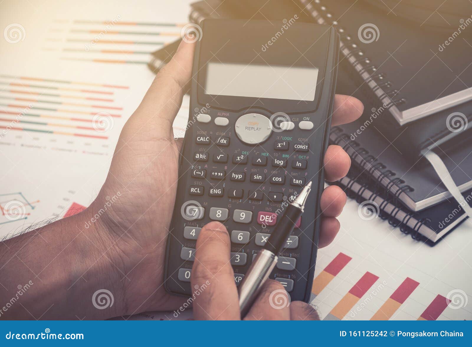 Business Man Using Calculator Analyzing Investment Chart on the Desk ... Business Man Using Calculator Analyzing Investment Chart on the Desk ...