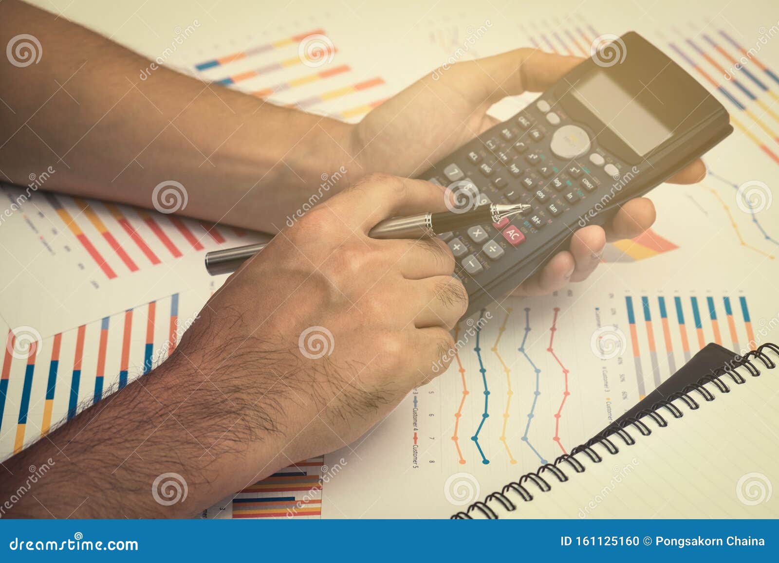 Business Man Using Calculator Analyzing Investment Chart on the Desk ... Business Man Using Calculator Analyzing Investment Chart on the Desk ...