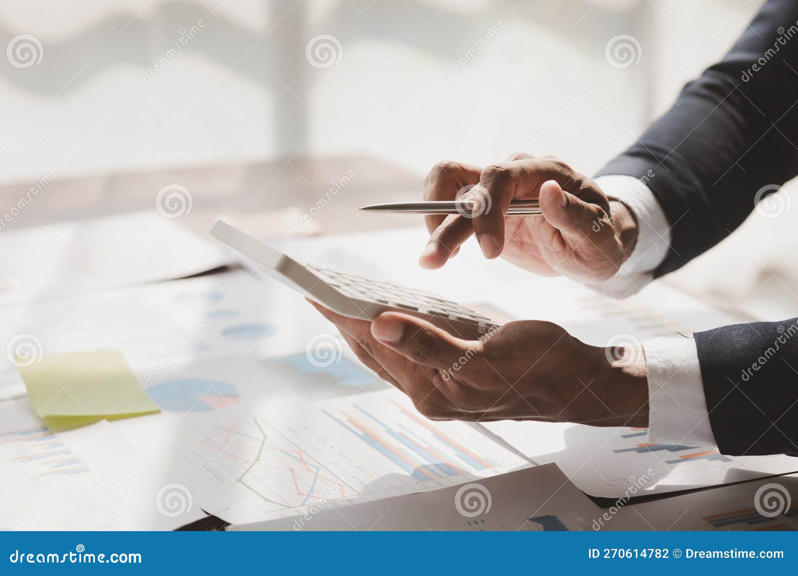 Business Man Using a Calculator To Calculate Numbers on a Company Stock ...