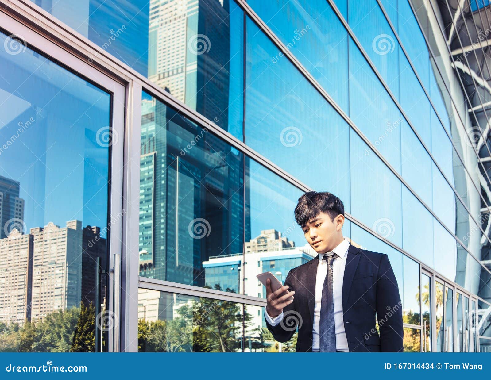 Business Man Using Mobile Phone and Standing in Front of Office ...