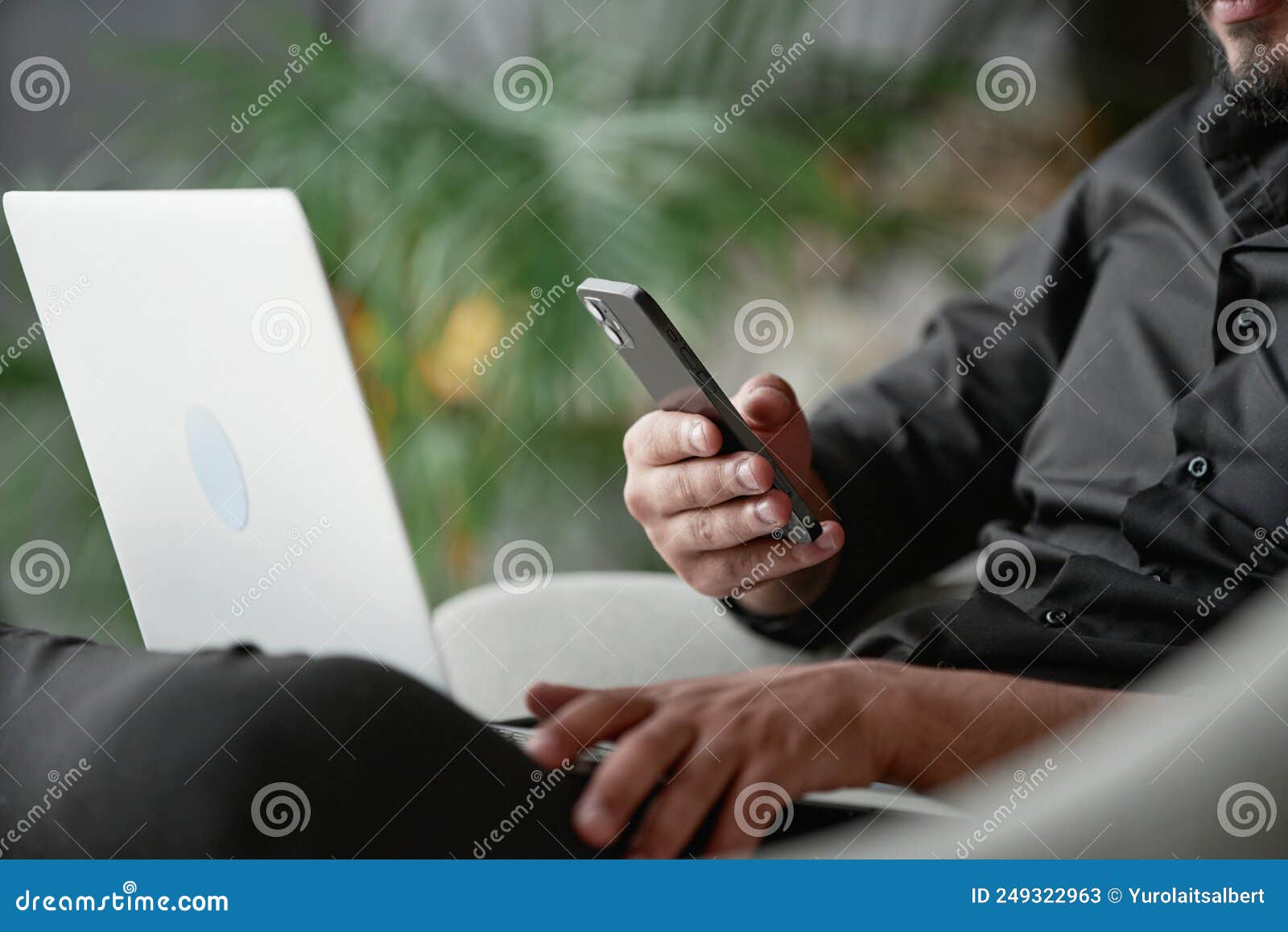 Business Man Using a Smartphone and a Laptop at the Same Time. Stock ...