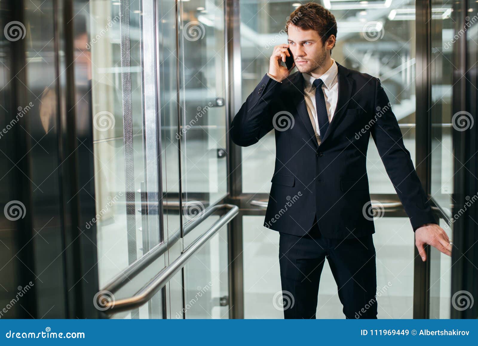 Business Man Walking while Talking on Mobile Phone on His Way To Work ...