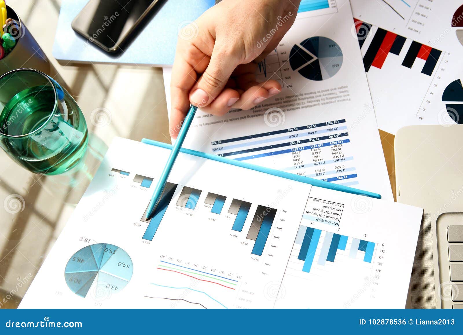 Business Man Working and Analyzing Financial Figures on a Graphs on a ...