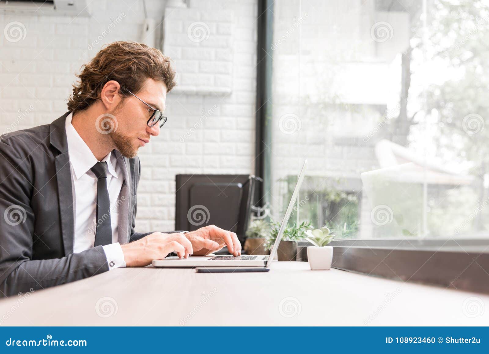 Business Man Working Hard with Laptop on Desk in Office Near Win Stock ... Business Man Working Hard with Laptop on Desk in Office Near Win Stock ...