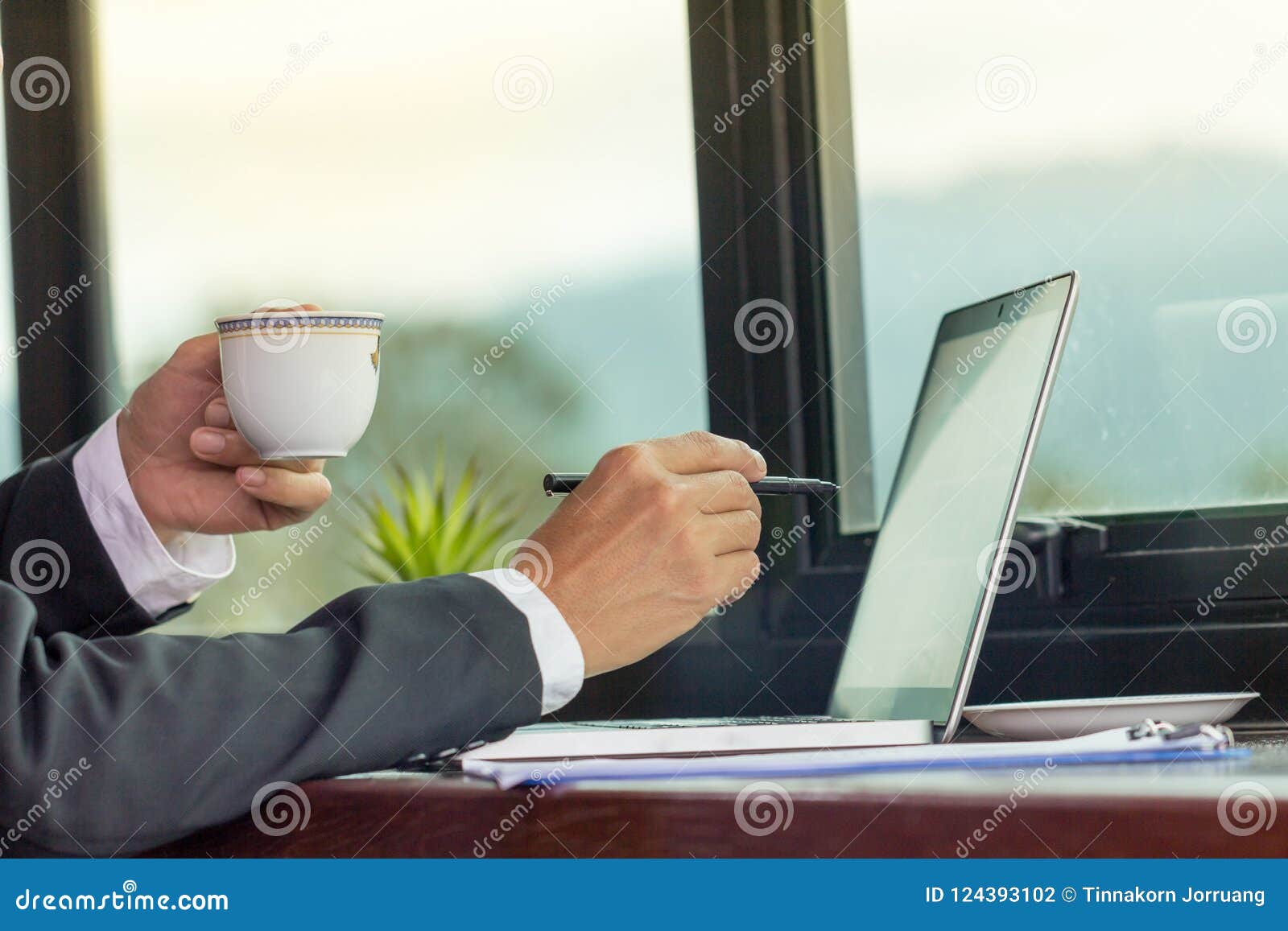 Business Man Working on Laptop Computer and Drinking Coffee. Stock ...