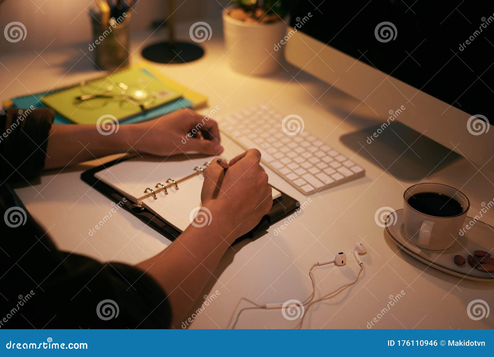 A Business Man is Writing in the Notebook while Sitting at His Working ...