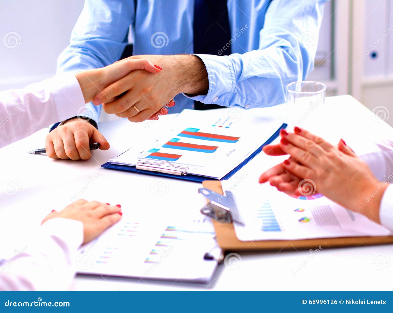 Business Meeting at the Table Shaking Hands Conclusion of the Contract ...