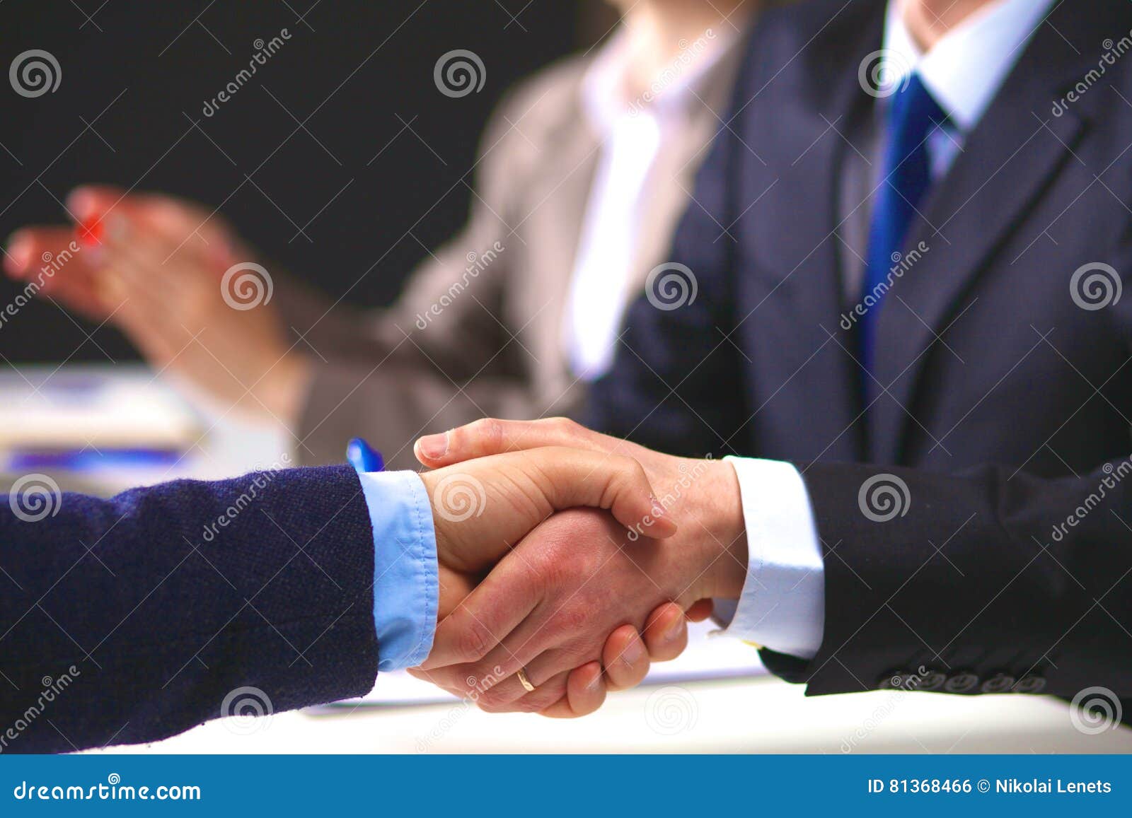 Business Meeting at the Table Shaking Hands Conclusion of the Contract ...