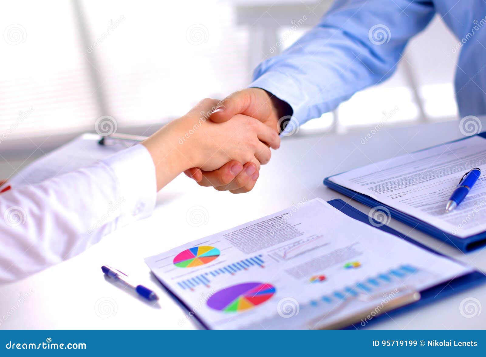 Business Meeting at the Table Shaking Hands Conclusion of the Contract ...