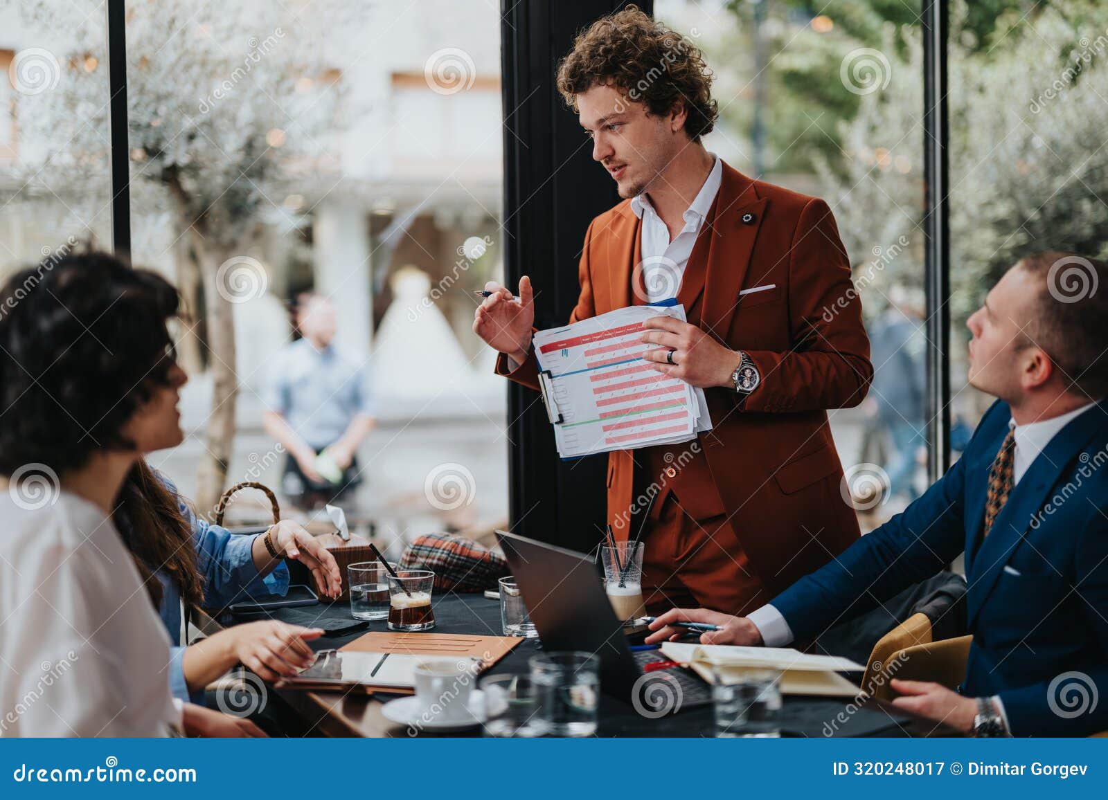 Business Meeting with Team Having a Discussion in a Modern Coffee Bar ...