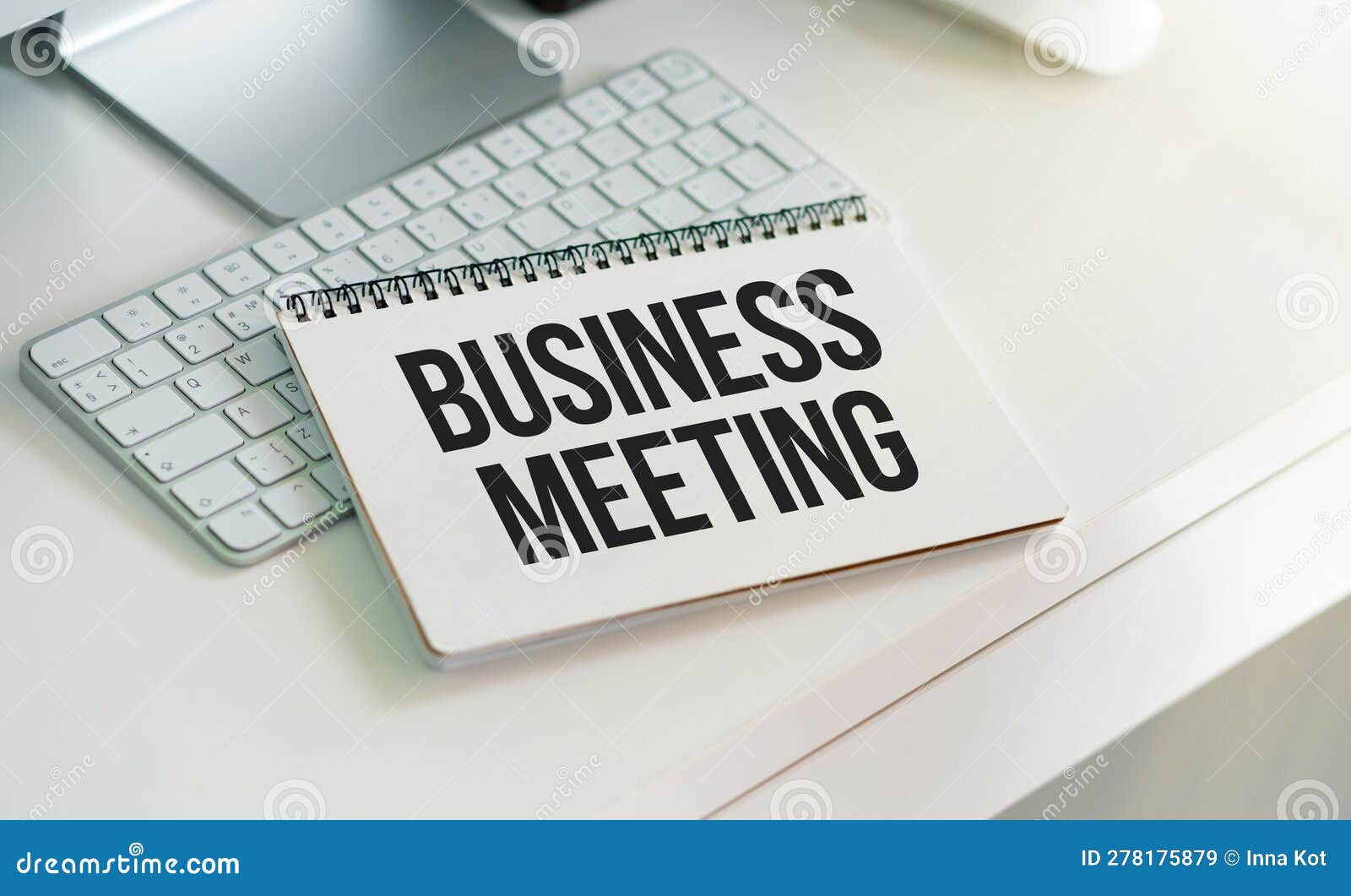 Business Meeting Text on a Notebook with Chart, Keyboard on White Table ...