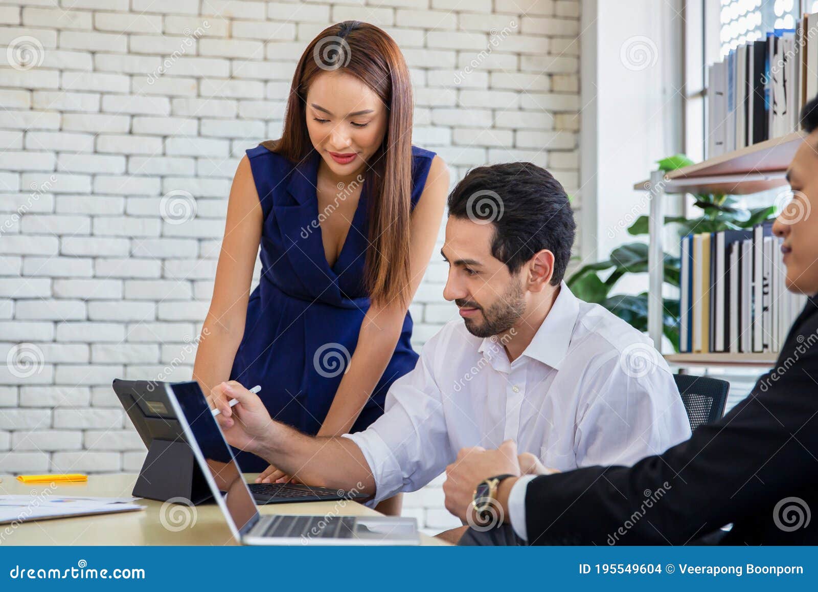 Business Man Using Modern Digital Tablet while Coworker Interacting in ...