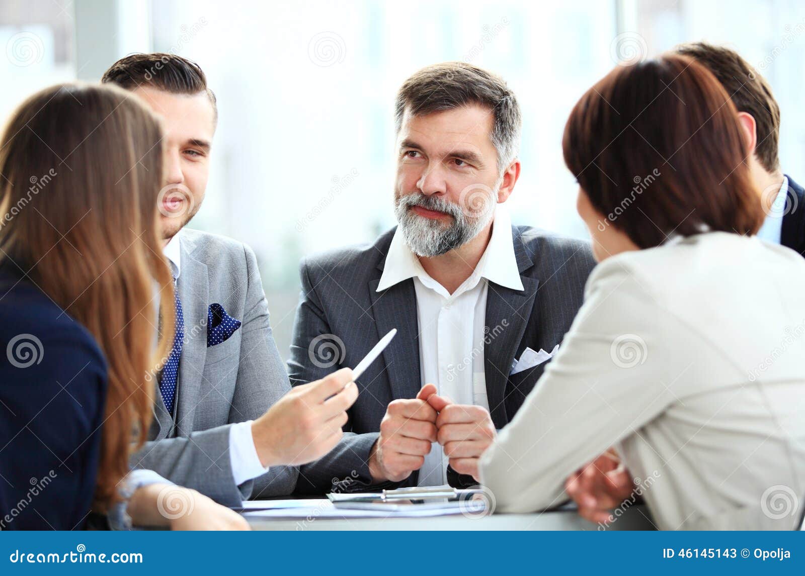 Business Partners Discussing Documents and Ideas at Meeting Stock Image ...