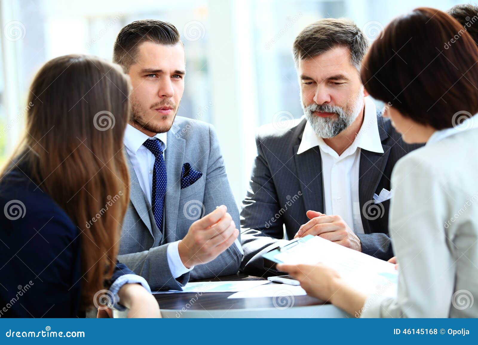 Business Partners Discussing Documents and Ideas at Meeting Stock Photo ...