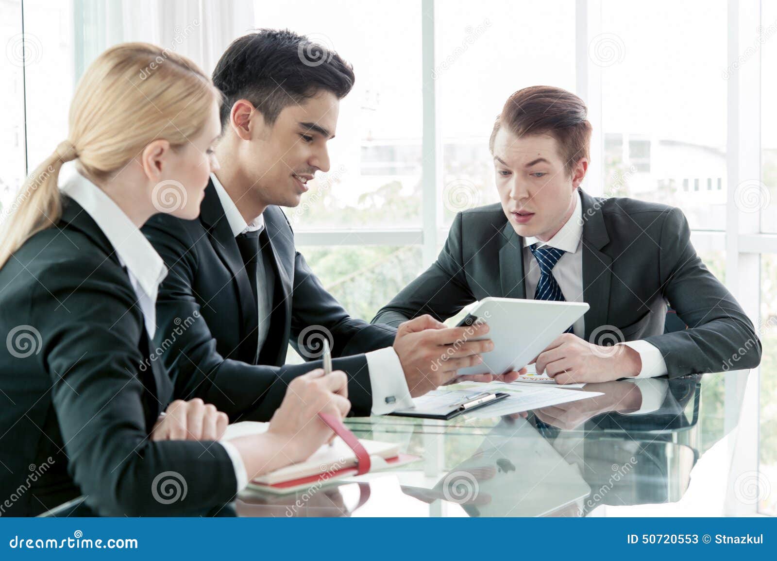 Business Partners Discussing Documents and Ideas at Meeting Stock Image ...