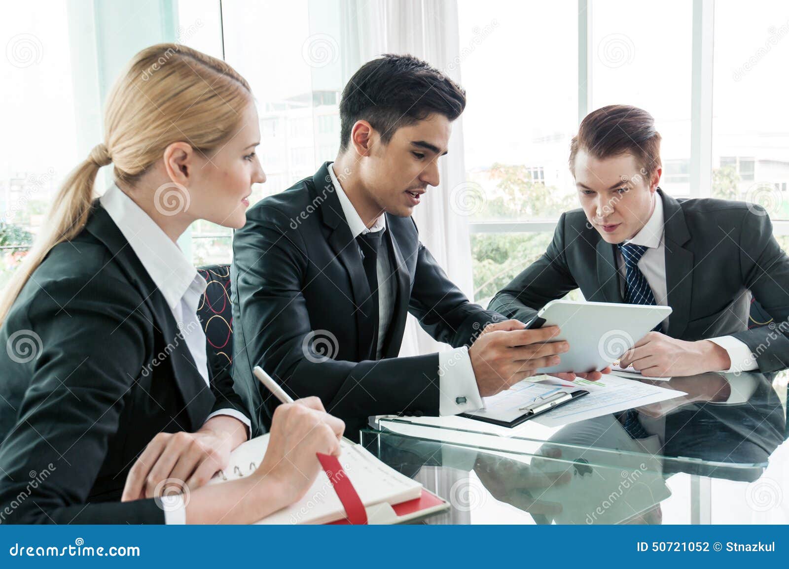 Business Partners Discussing Documents and Ideas at Meeting Stock Photo ...