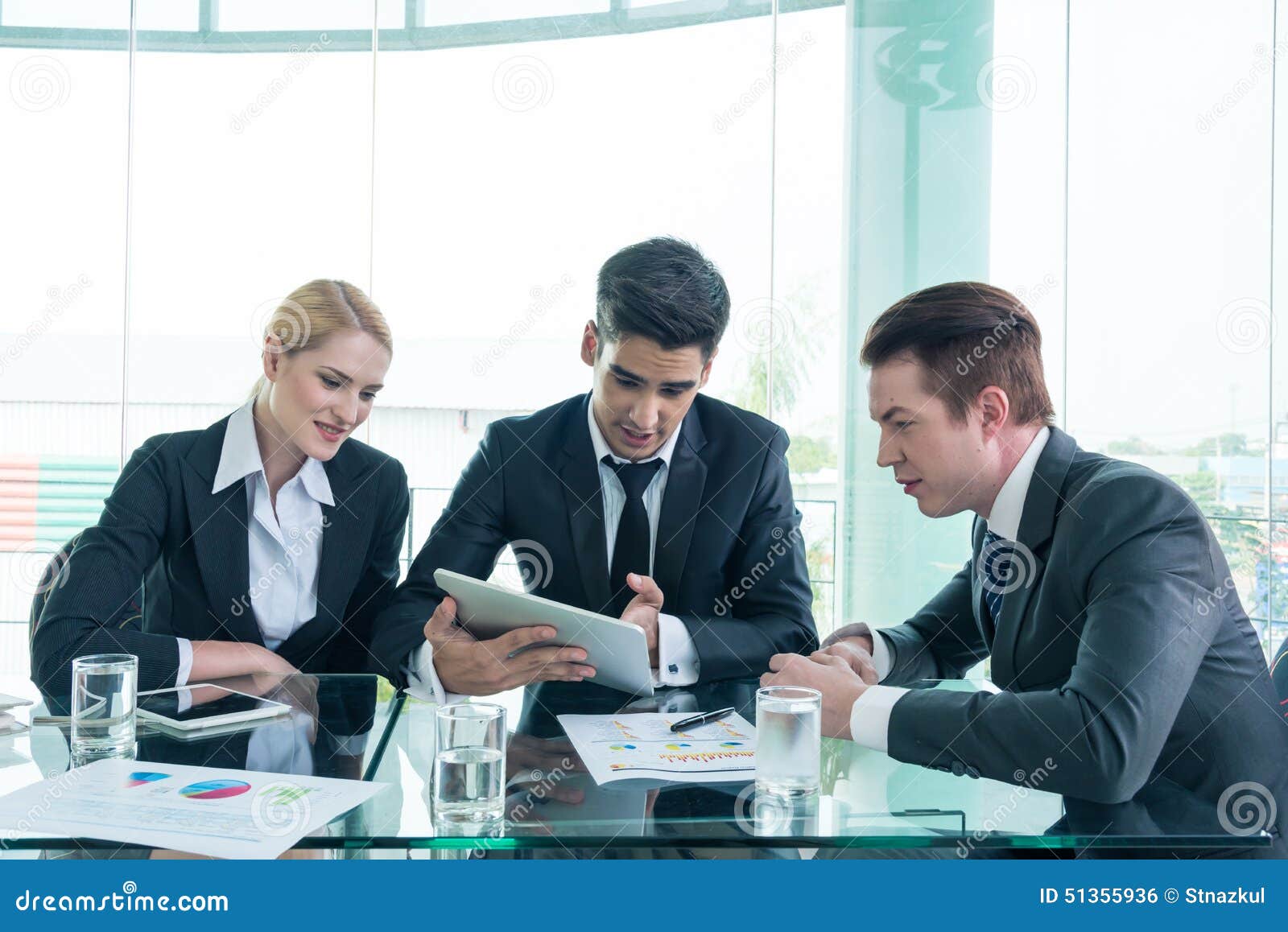 Business Partners Discussing Documents and Ideas at Meeting Stock Photo ...