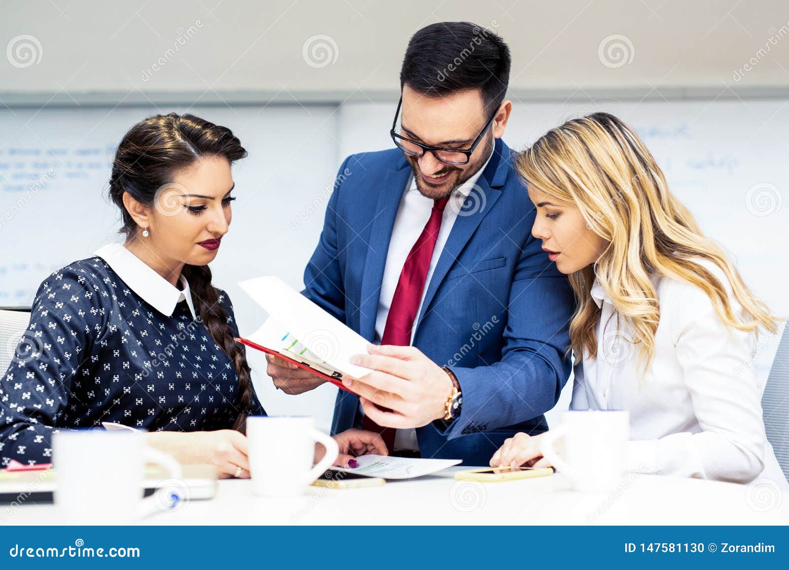 Business Partners Discussing Documents and Ideas at Meeting Stock Photo ...