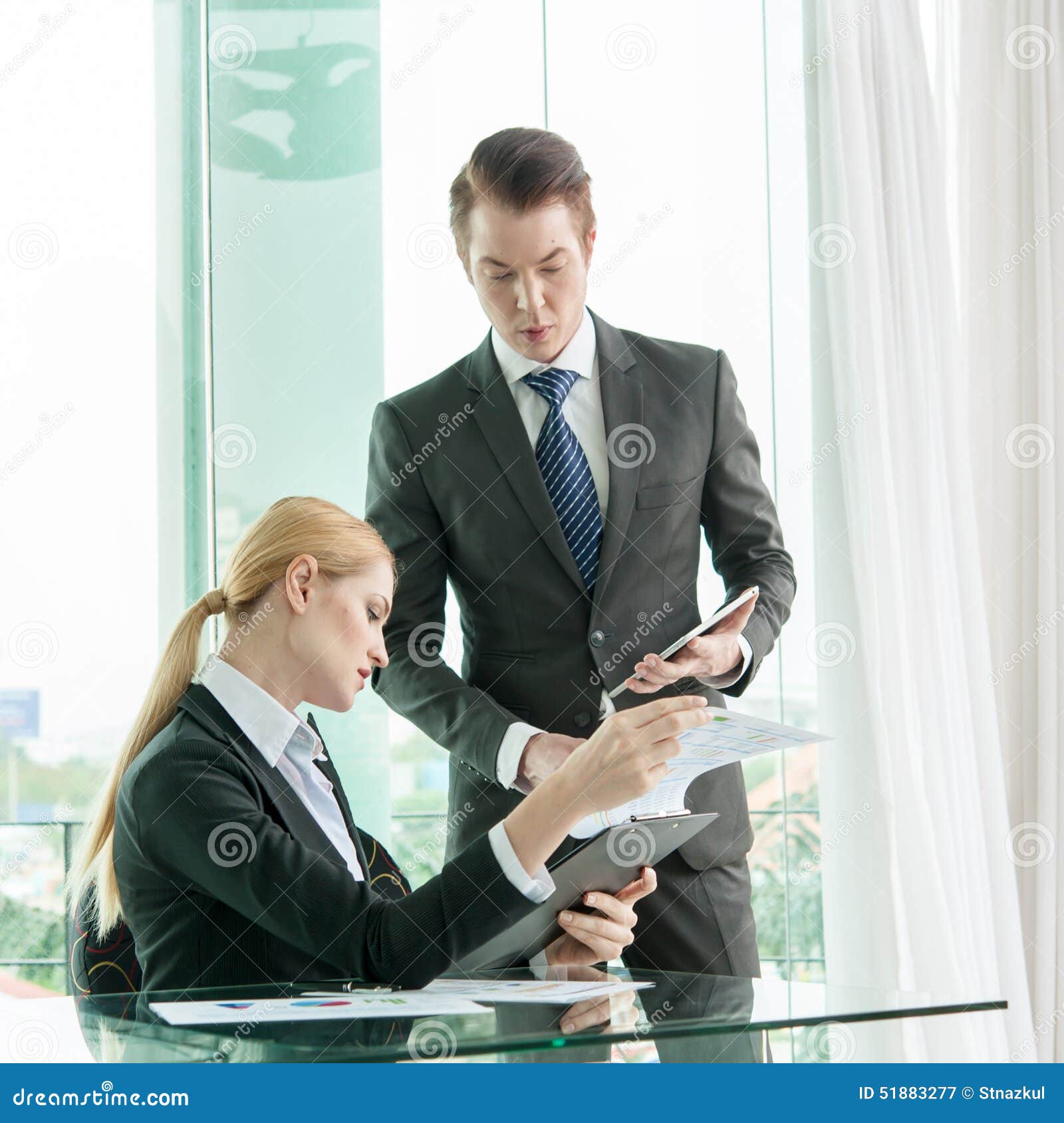 Business Partners Discussing Documents and Ideas in Office Stock Image ...