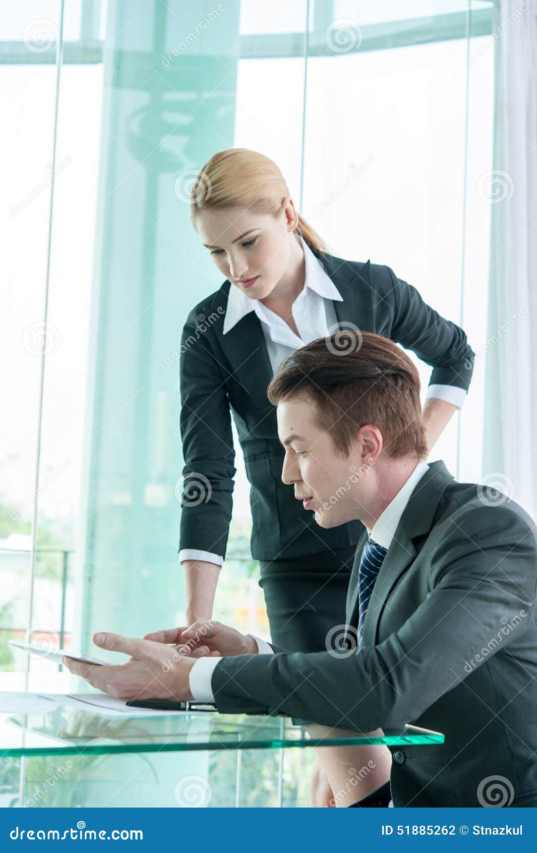 Business Partners Discussing Documents and Ideas in Office Stock Photo ...