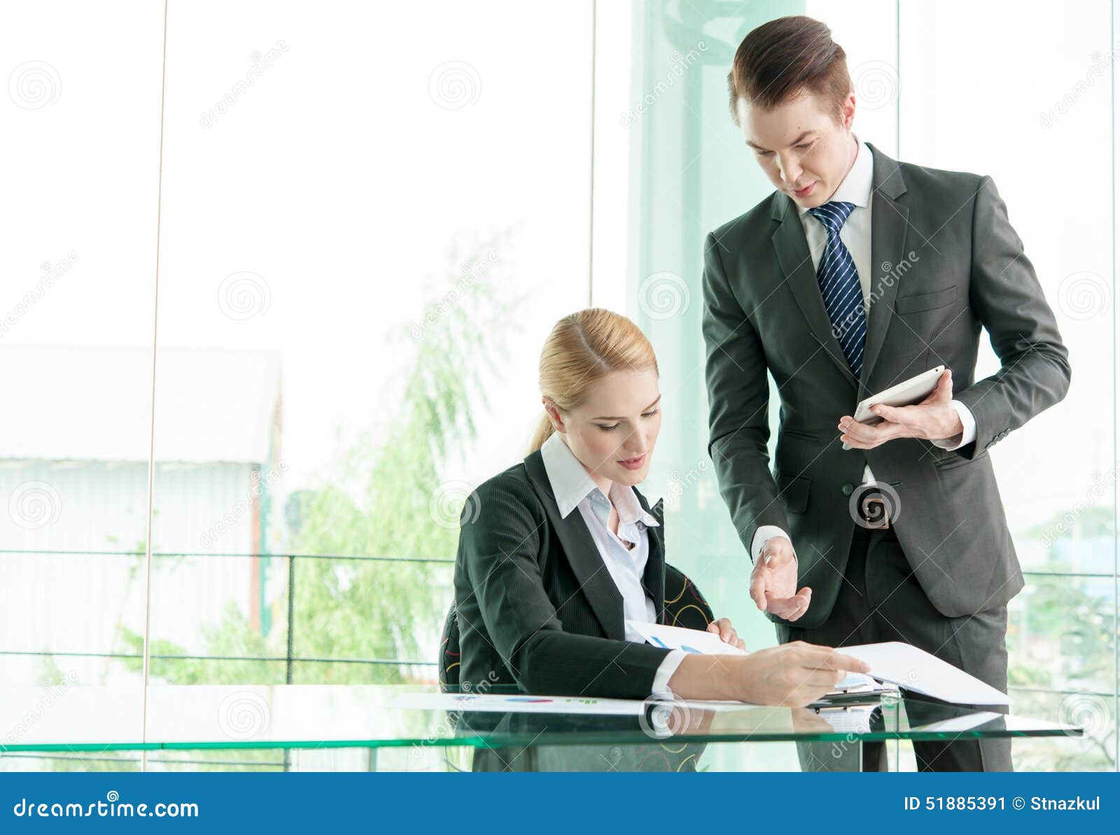 Business Partners Discussing Documents and Ideas in Office Stock Image ...