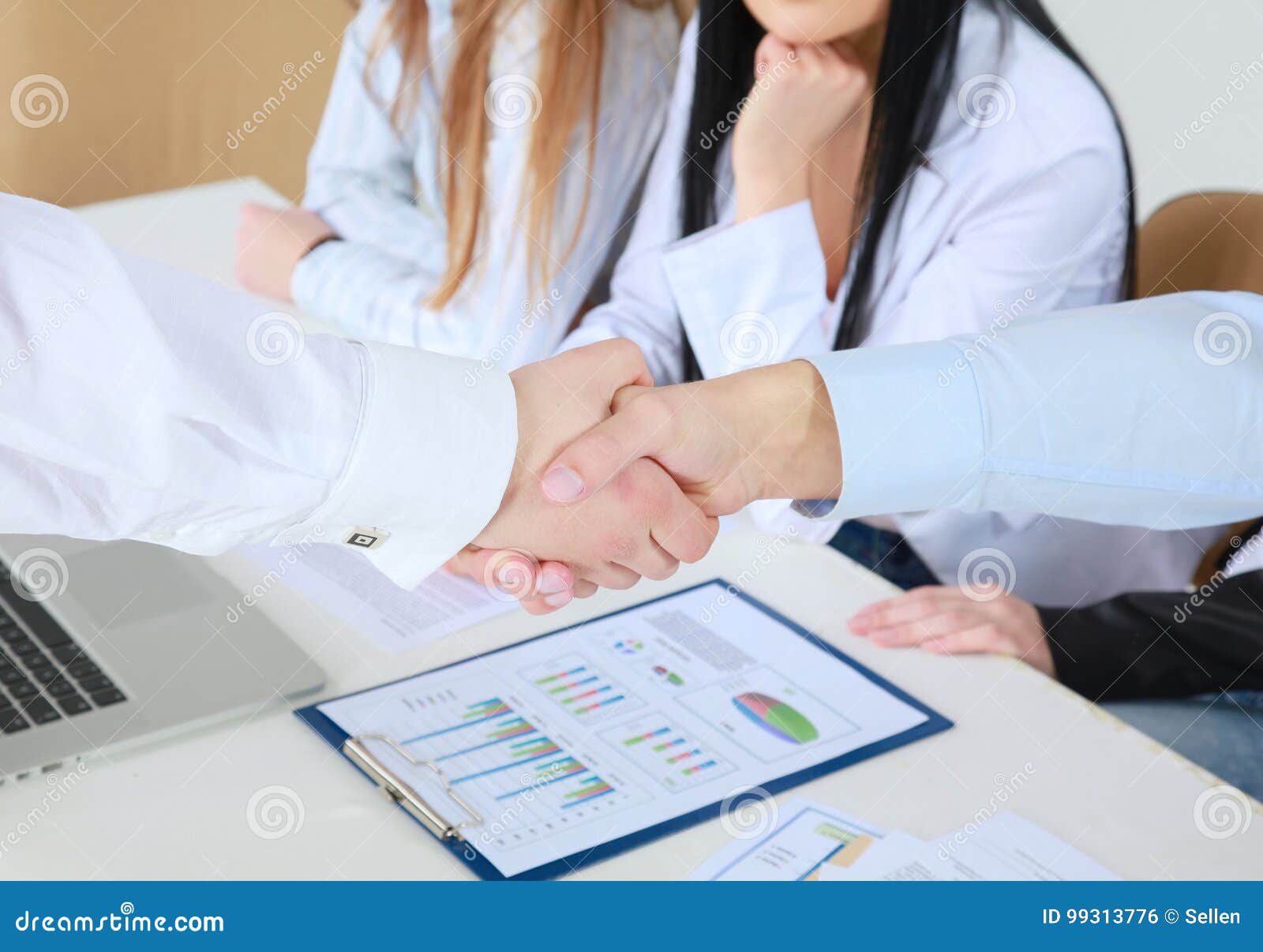 Business Partners Handshaking Over Business Objects on Workplace Stock ...