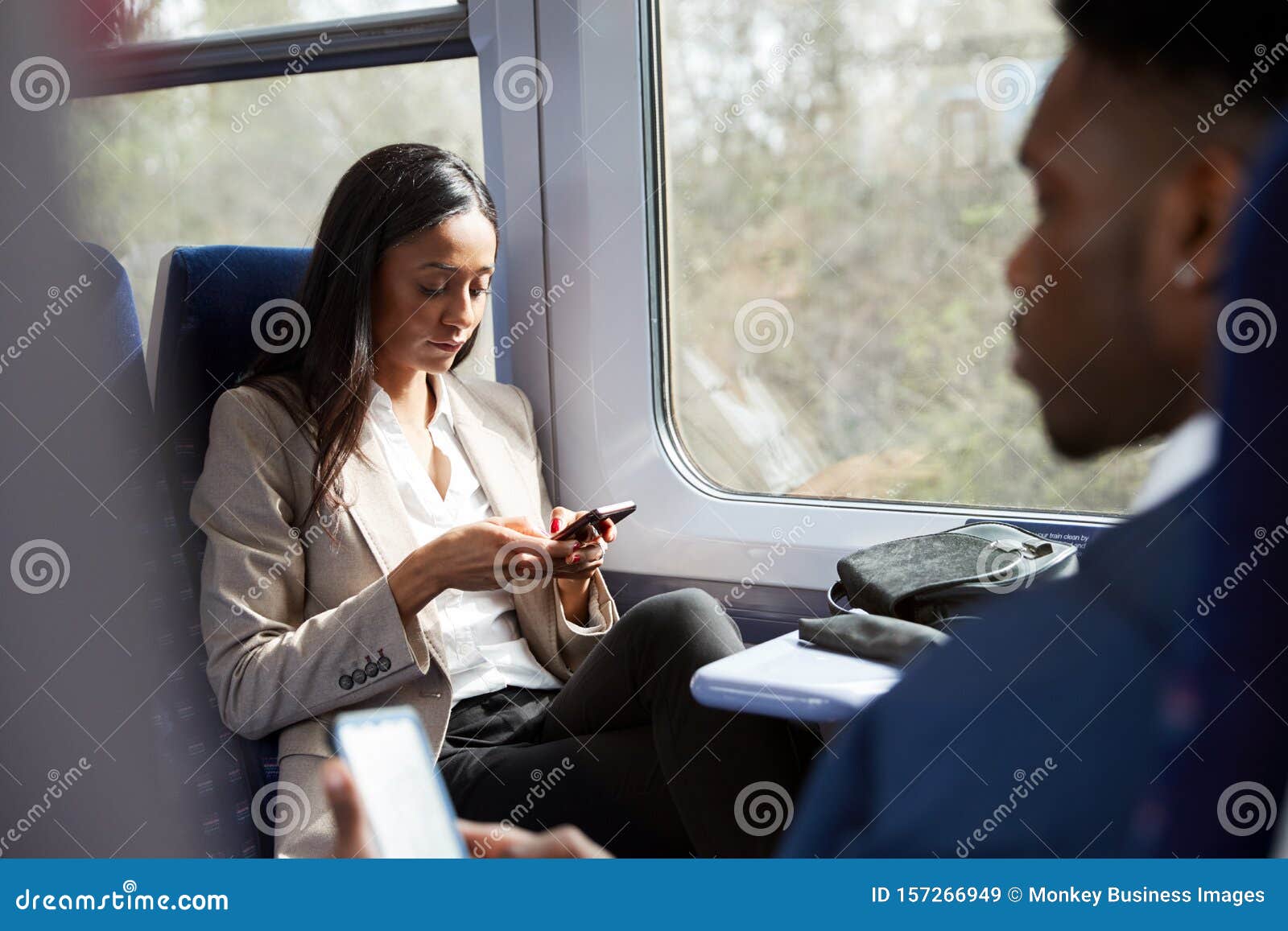 Business Passengers Sitting in Train Commuting To Work Looking at ...