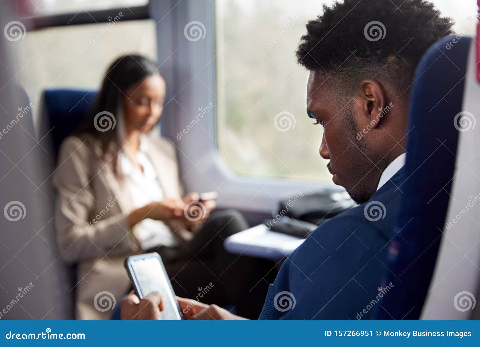 Business Passengers Sitting in Train Commuting To Work Looking at ...