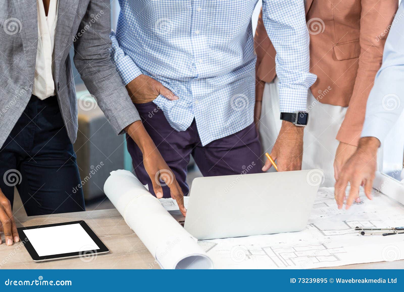Business People with Blueprint on the Desk Using Laptop Stock Image ...