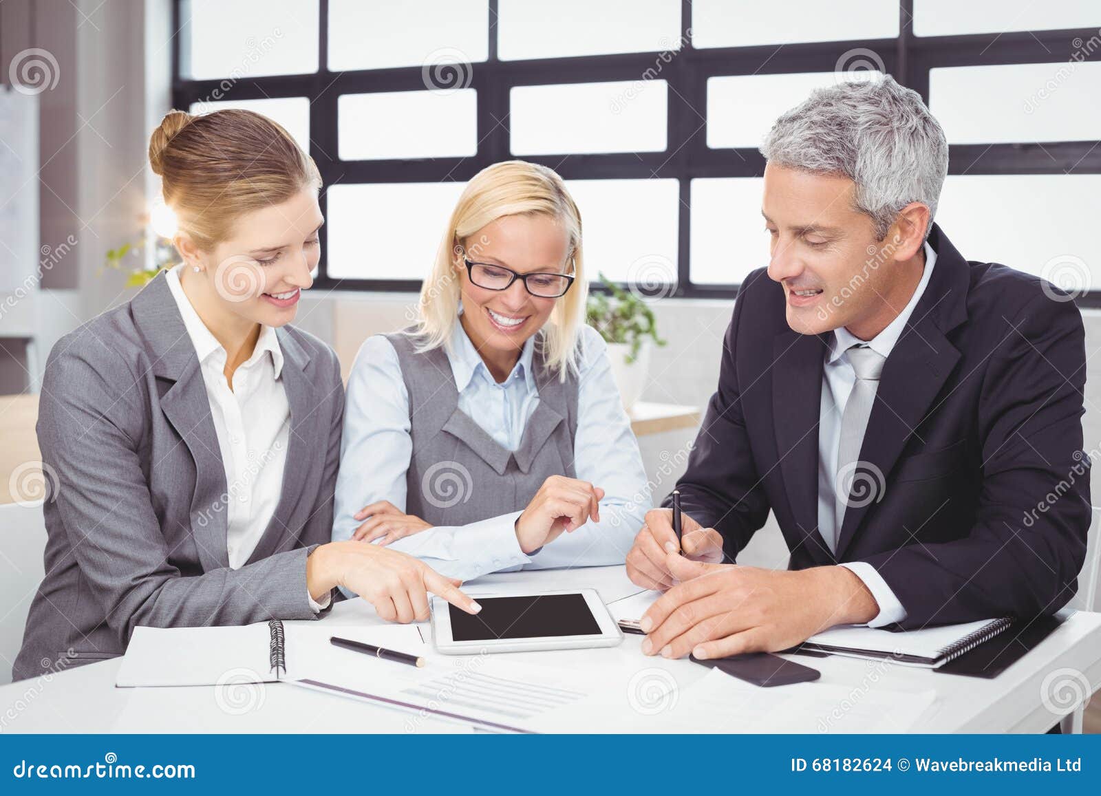 Business People Discussing with Client Over Digital Tablet Stock Photo ...