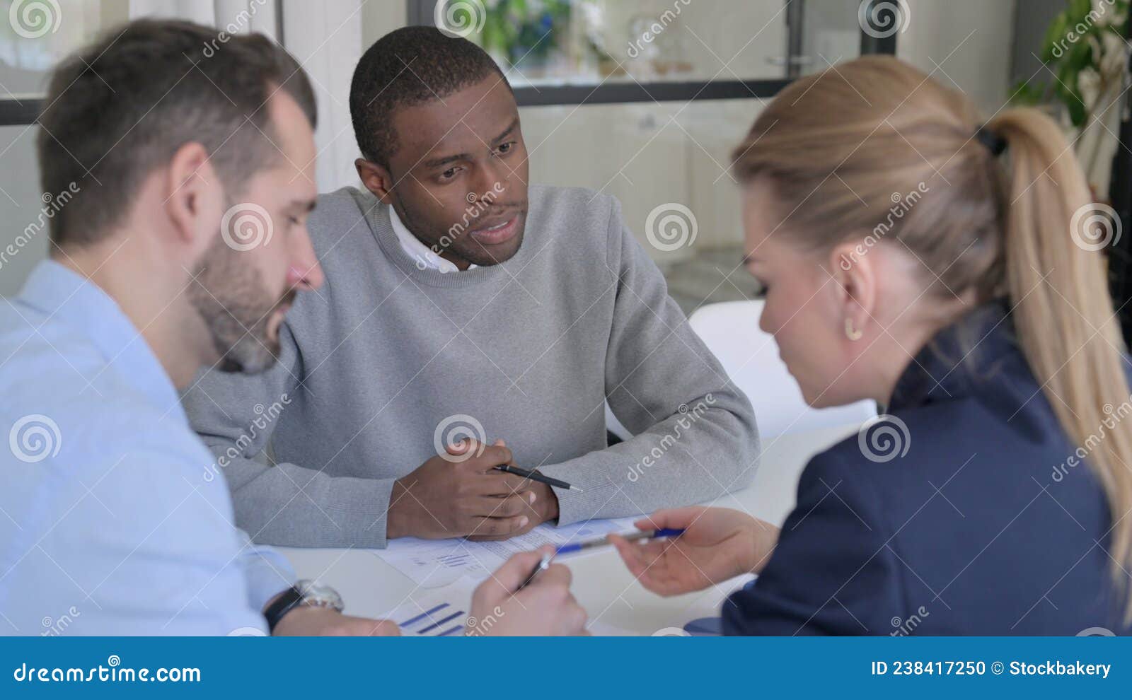 Business People Discussing Documents in Office Stock Photo - Image of ...