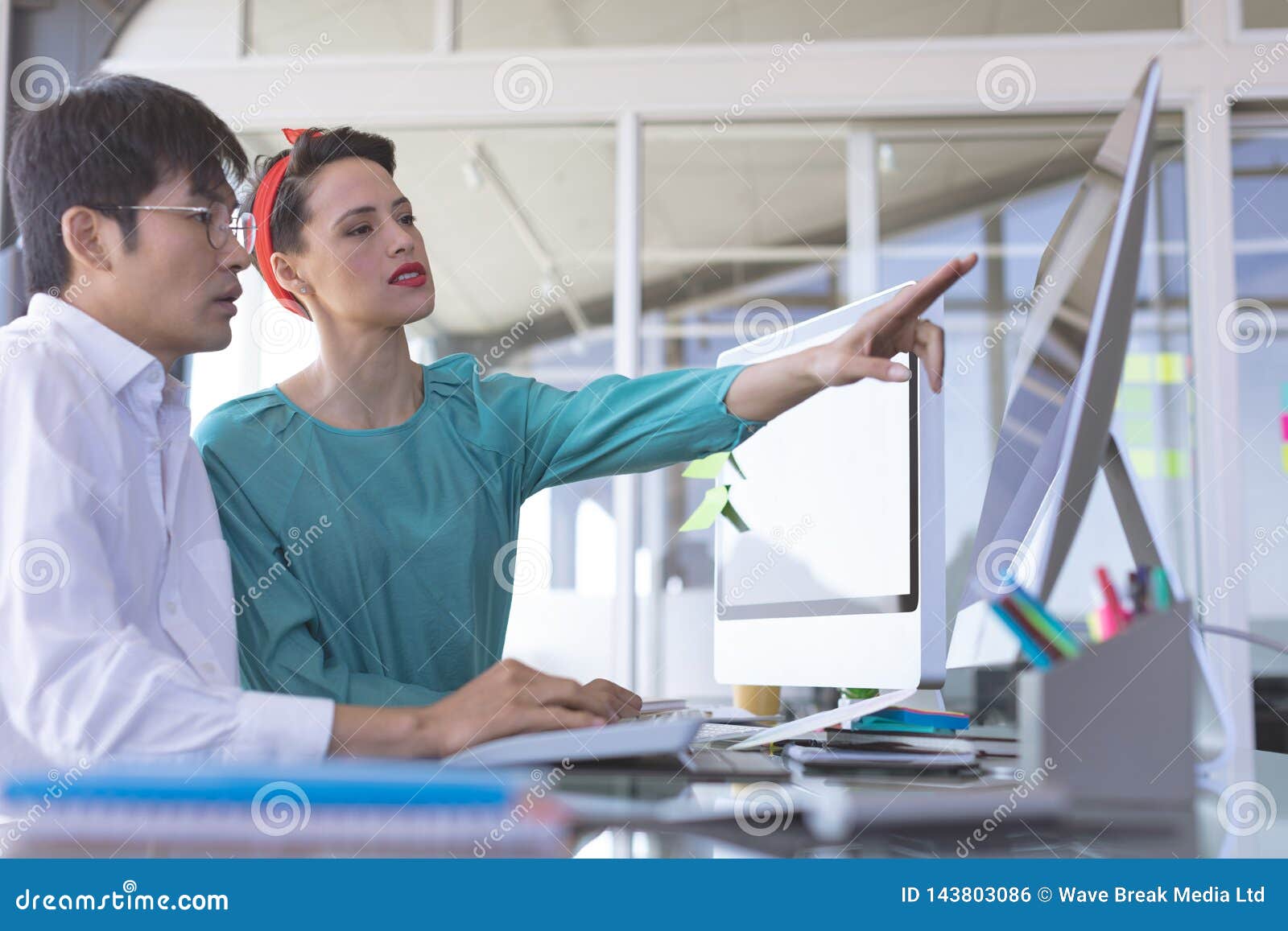 Business People Discussing Over Computer at Desk in Office Stock Photo ...