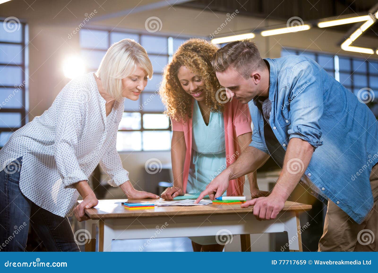 Business People Discussing Over Documents at Desk Stock Image - Image ...