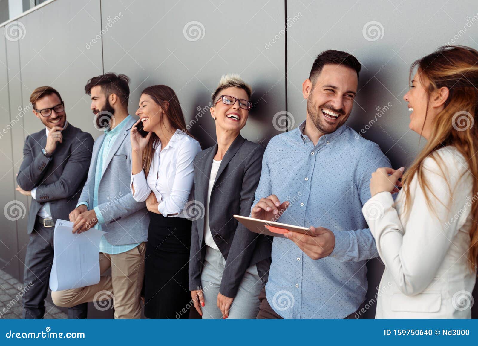 Business People Discussing Over Documents in Office Lobby. Stock Photo ...