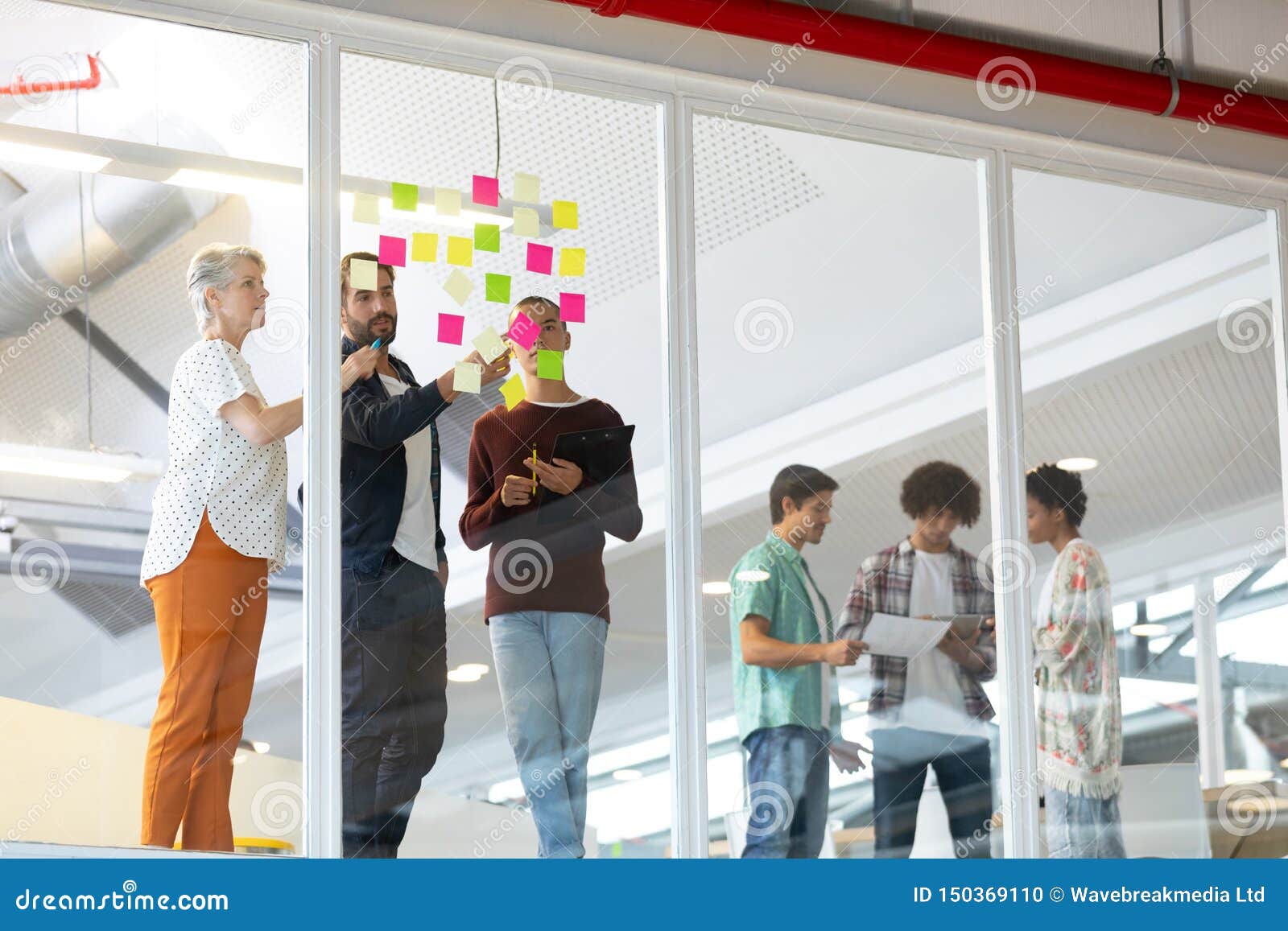 Business People Discussing Over Sticky Notes in the Office Stock Photo ...